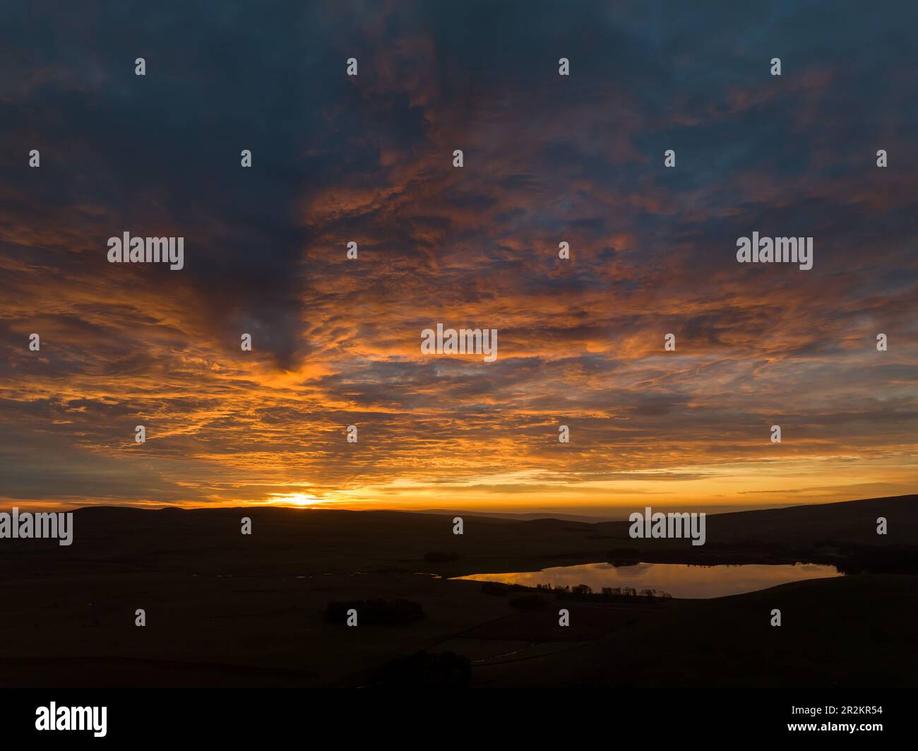 A breathtaking panoramic view of Malham Tarn at sunset, reflecting the ...