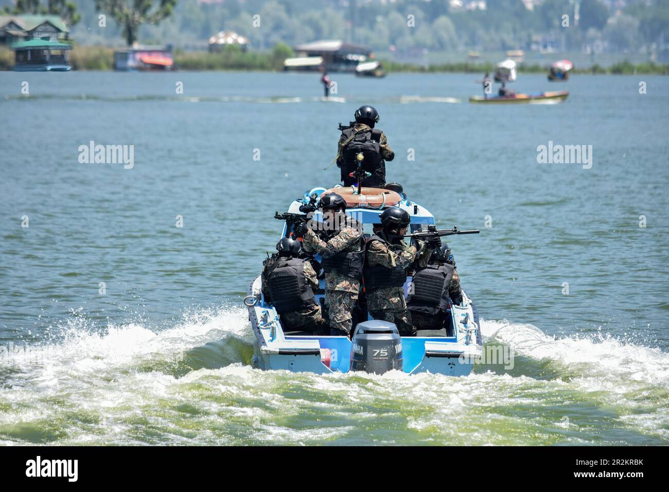 Srinagar, India. 20th May, 2023. Indian paramilitary troopers take position in a motorboat as ...