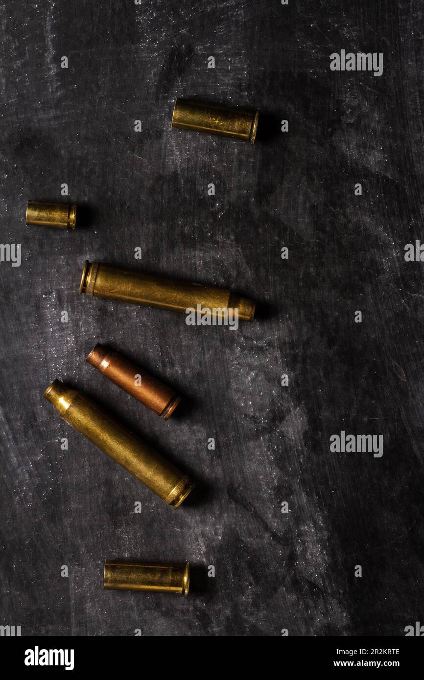 Empty bullet cartridges lying on the black background Stock Photo - Alamy