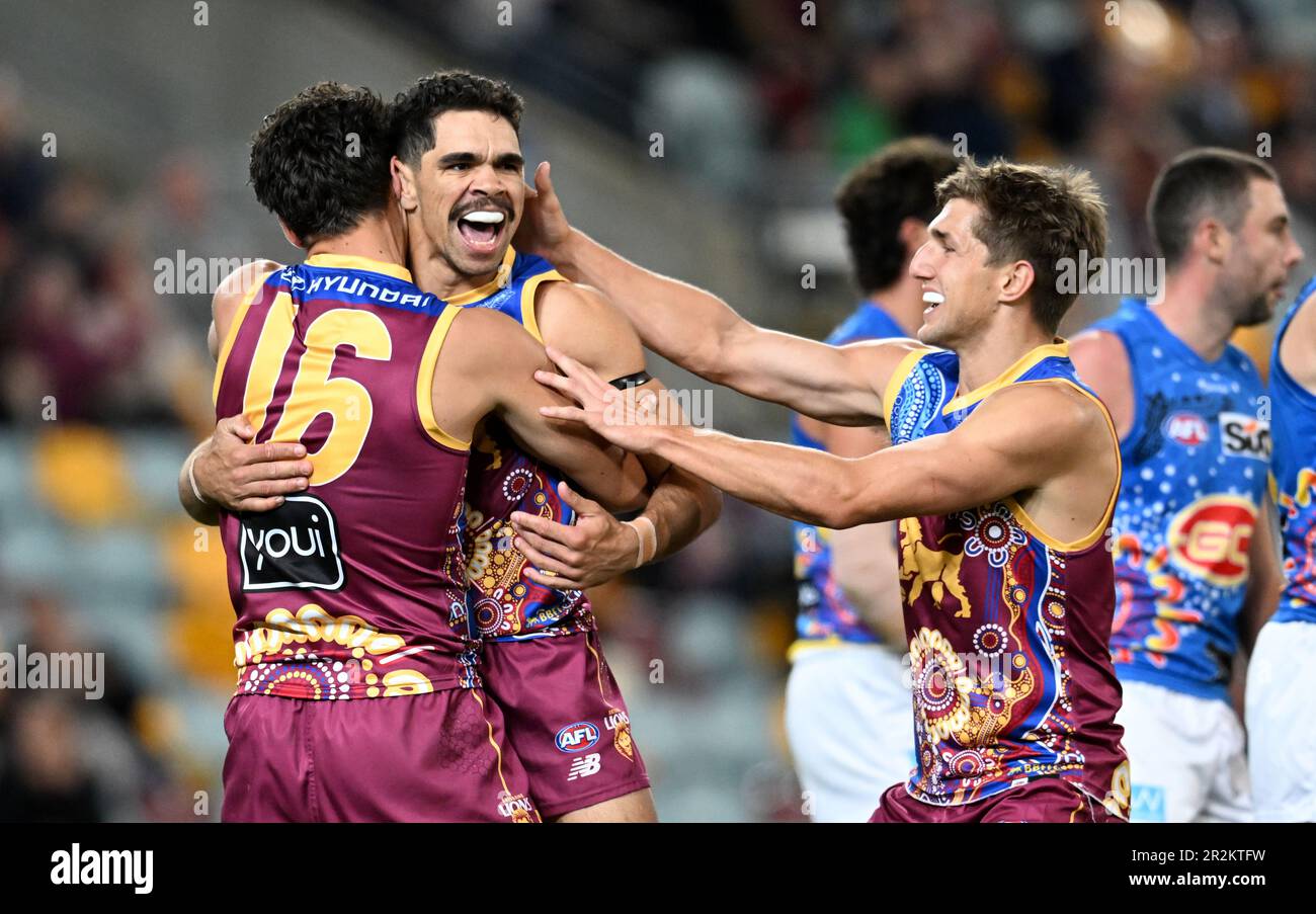 Charlie Cameron (centre) of the Lions celebrates kicking a goal with ...