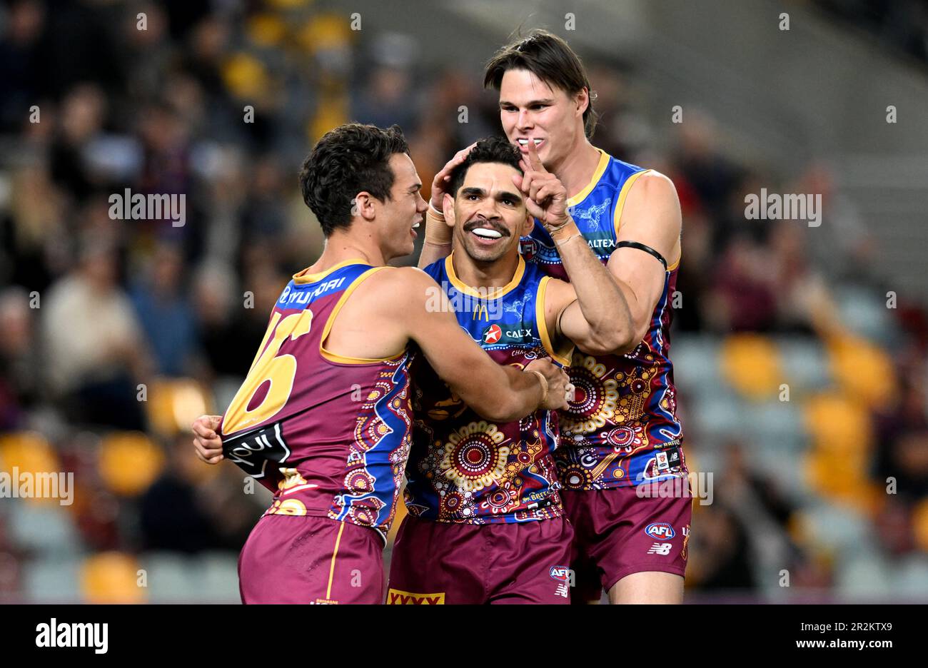 Charlie Cameron (centre) of the Lions celebrates kicking a goal with ...
