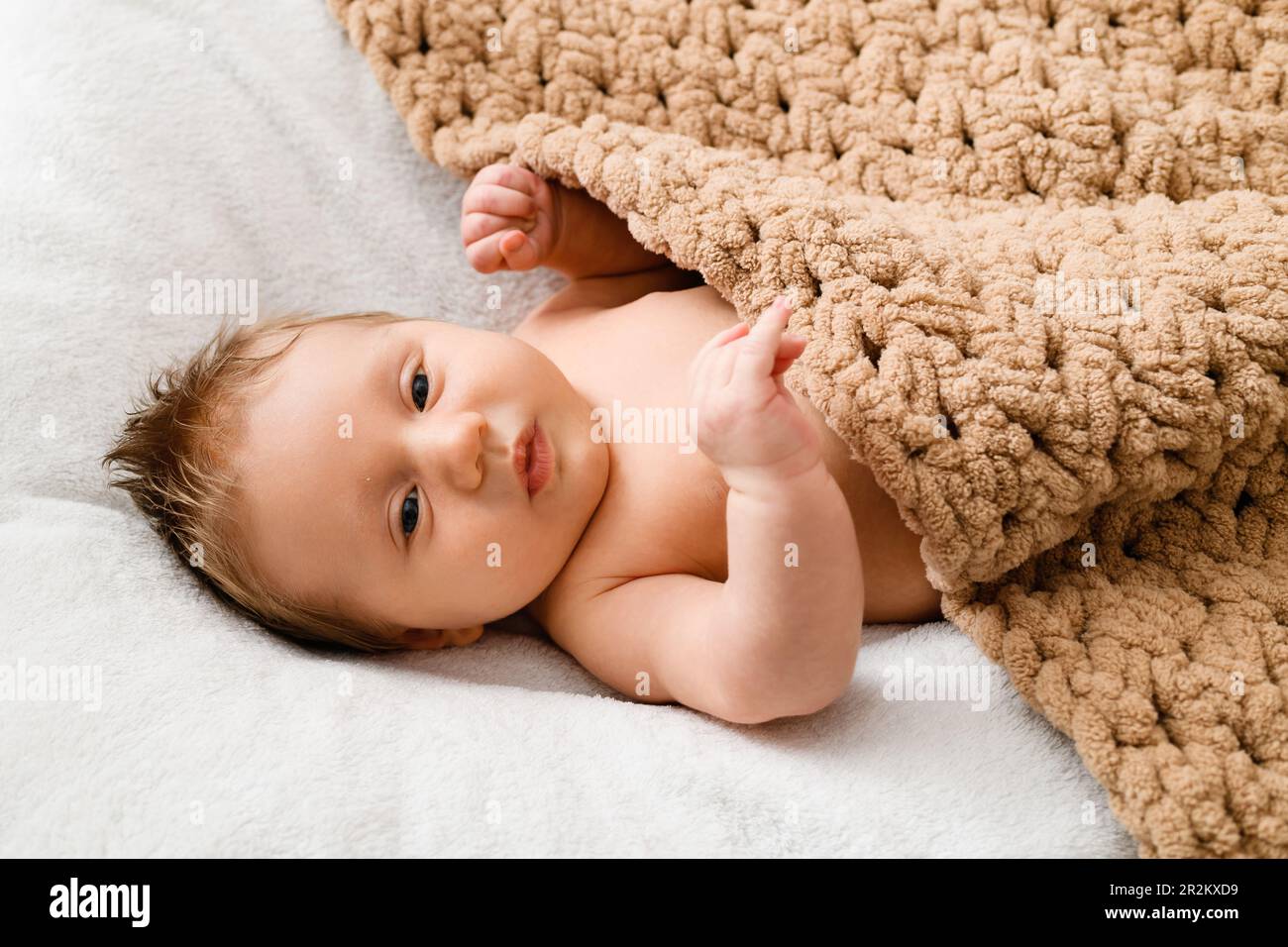 Top view of cute infant baby laying on his back in a wooden cot Stock ...