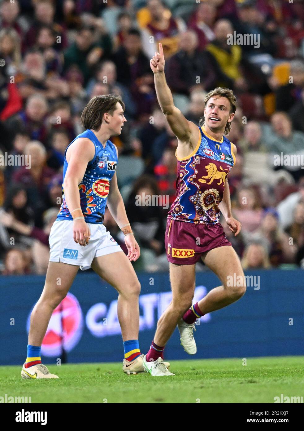 Harry Sharpe (right) of the Lions celebrates kicking a goal during the ...