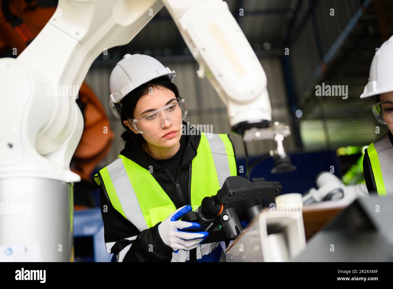 Couple of happy female maintenance engineers working at factory Stock ... Couple of happy female maintenance engineers working at factory Stock ...