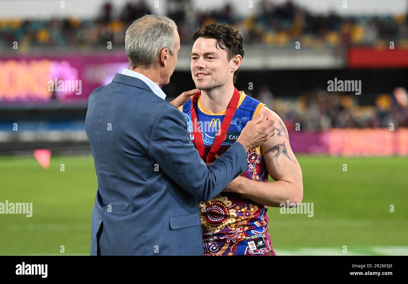 Lachie Neale (right) of the Lions is presented with the Marcus Ashcroft ...