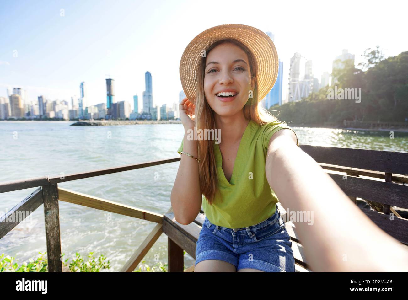 Happy smiling stylish female model takes self portrait with her ...