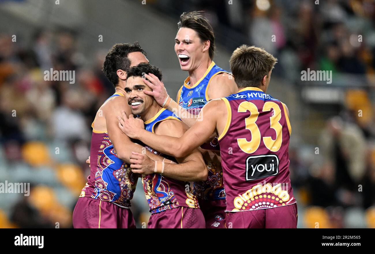 Charlie Cameron (centre) of the Lions celebrates kicking a goal with ...