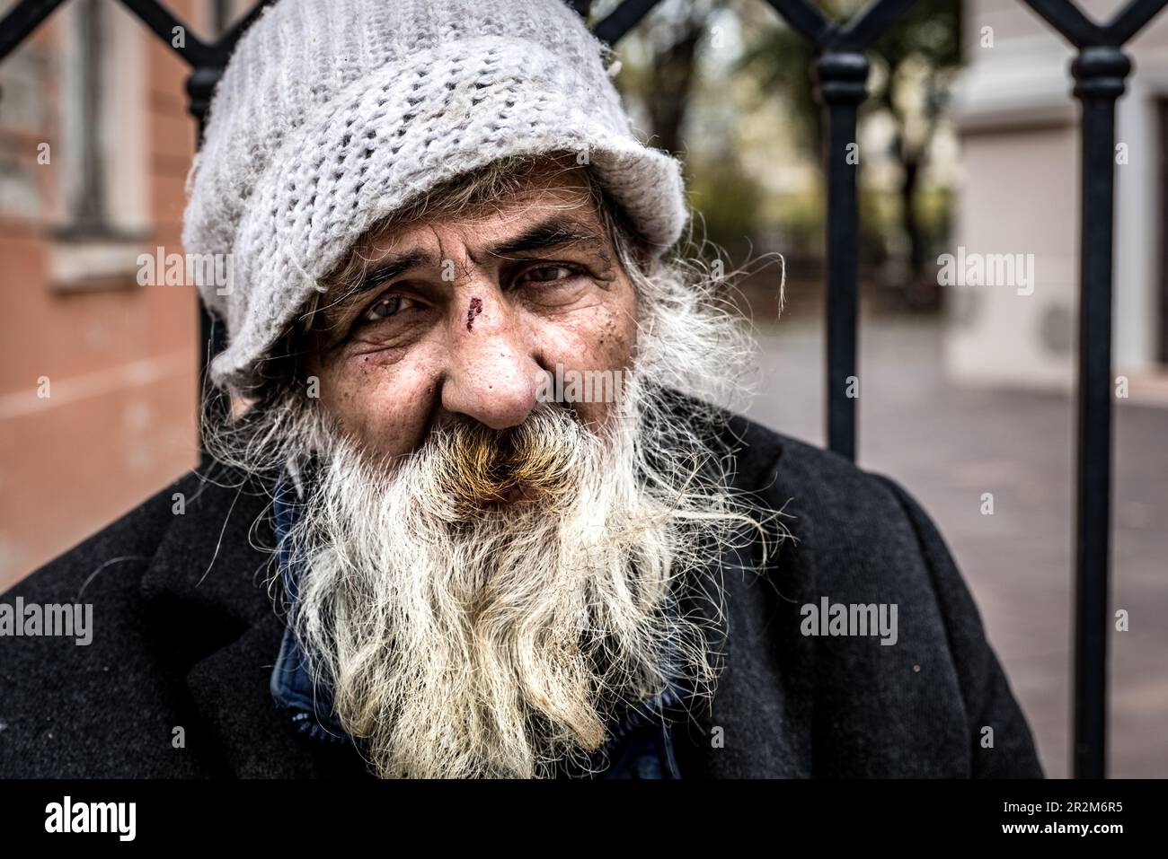 Close up portrait of old homeless alcoholic man face with white beard ...