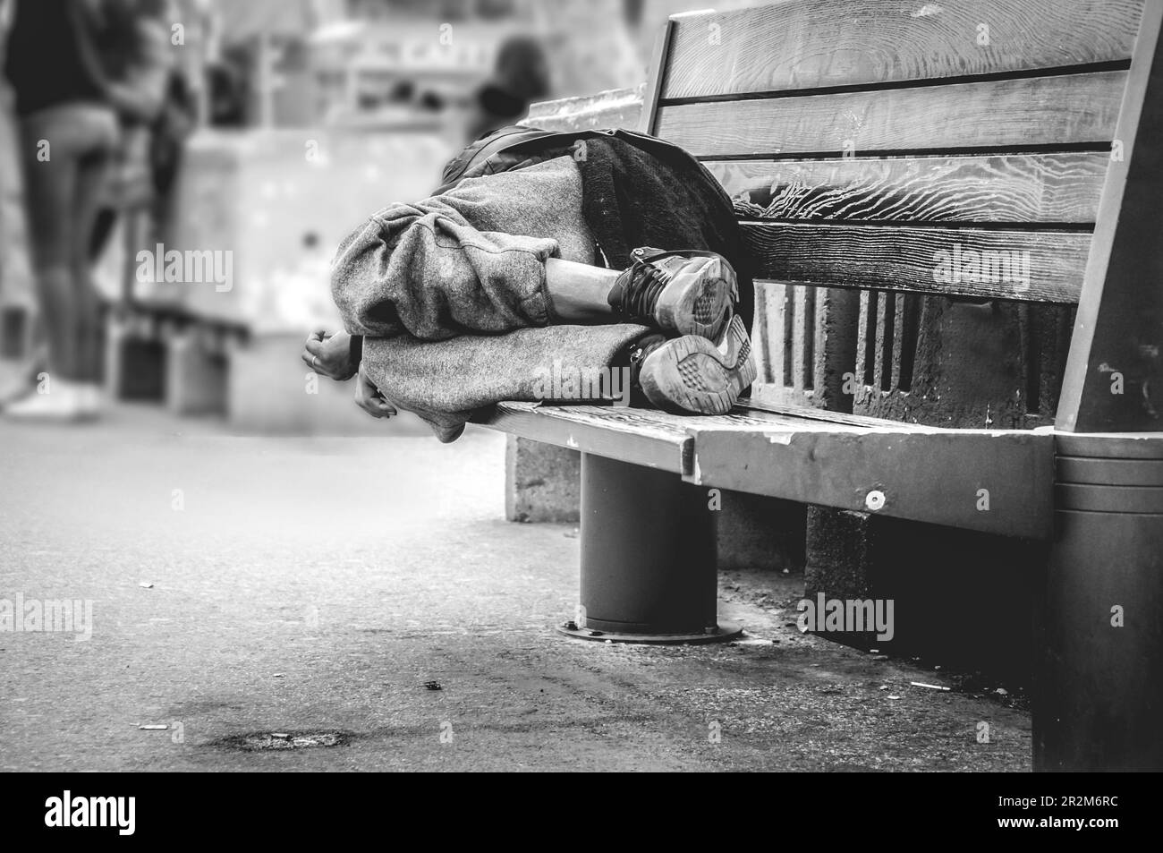 Poor tired depressed hungry homeless man or refugee sleeping on the ...
