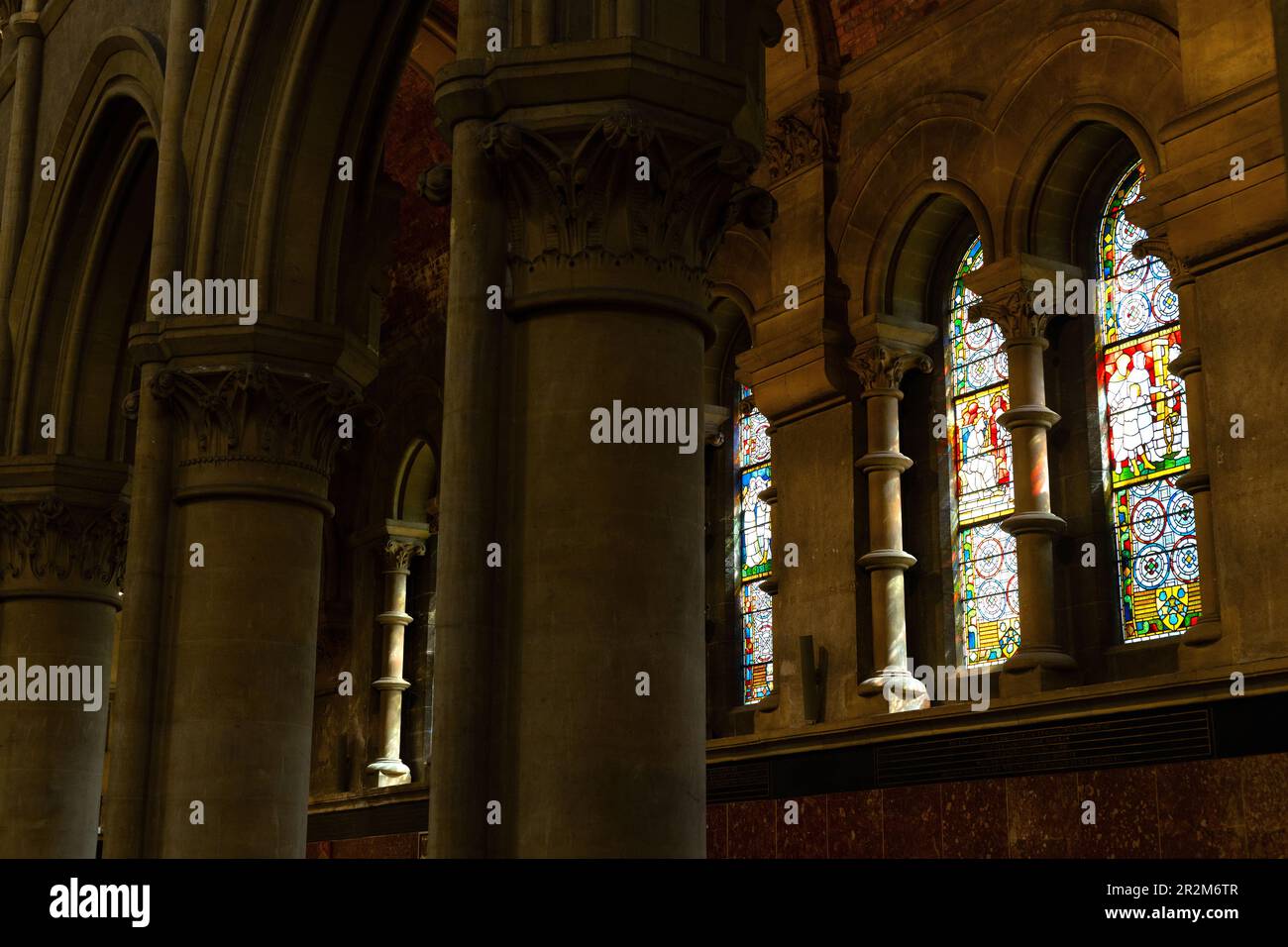 Pillars and colorful stained glass windows inside Saint Fin Barre's ...