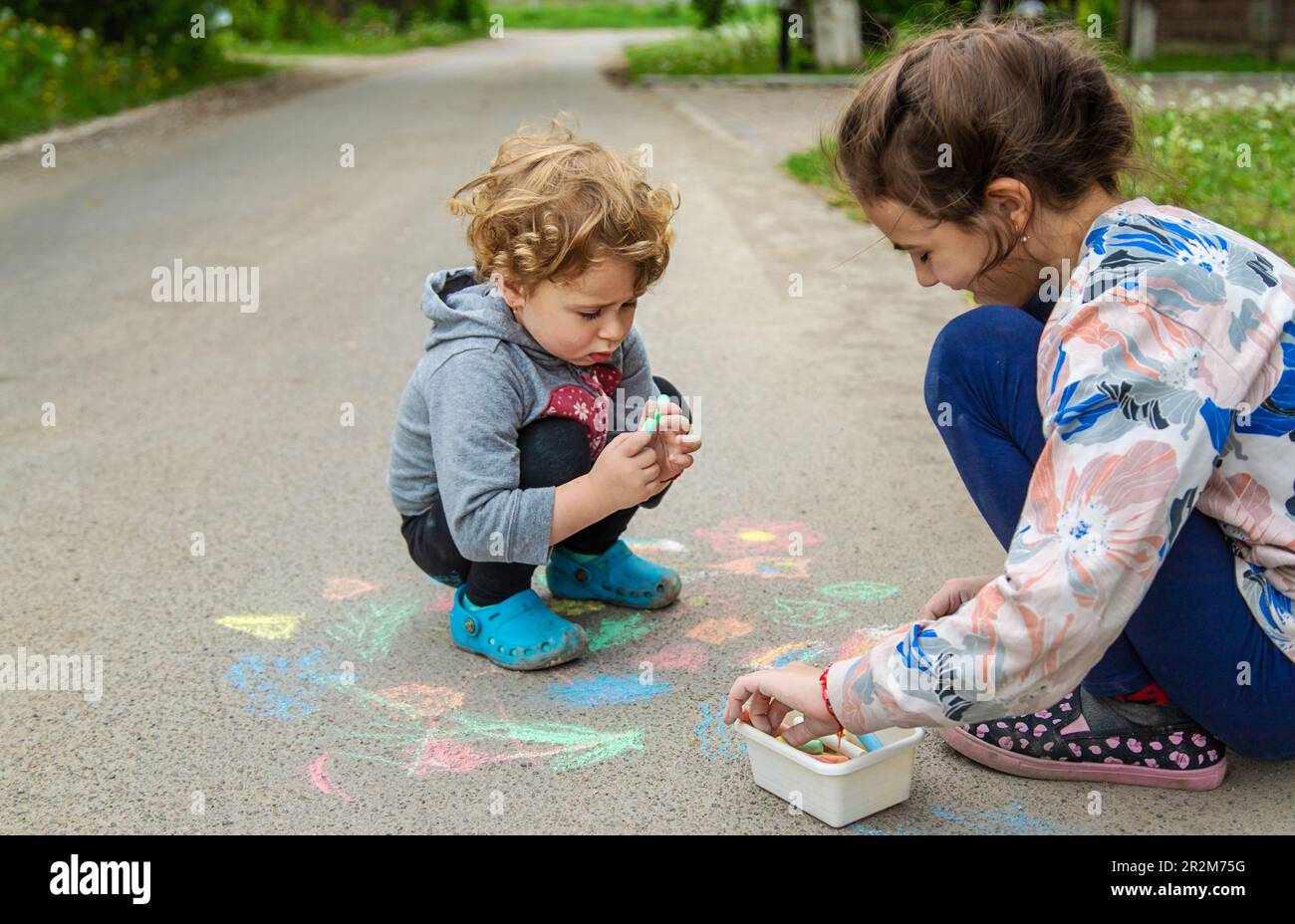 Children draw with chalk on the pavement. Selective focus. Kid Stock ...