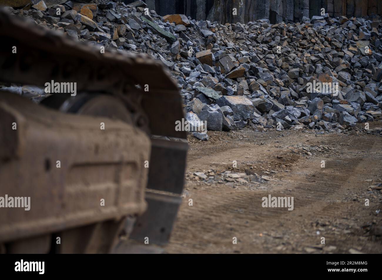 Excavator caterpillar in a basalt quarry. Extraction of basalt, granite ...