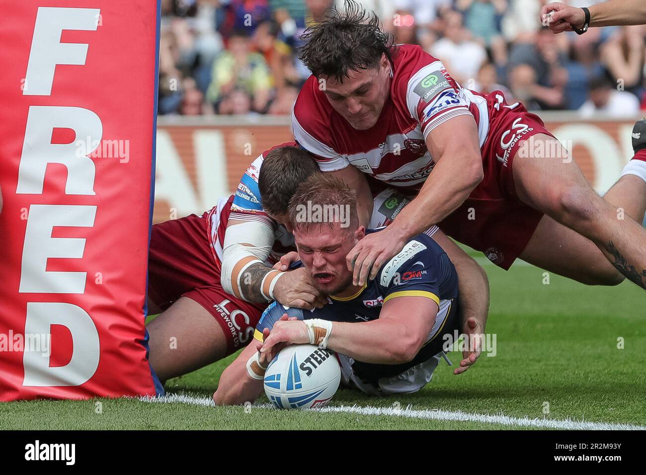 Tom Holroyd #18 of Leeds Rhinos goes over for a try and makes the score ...