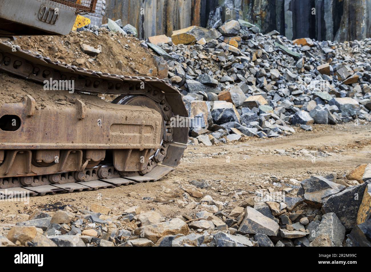 Excavator caterpillar in a basalt quarry. Extraction of basalt, granite ...