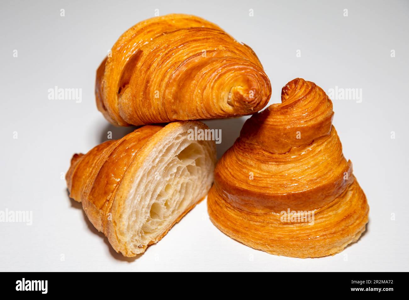 Golden brown butter croissant with shadow isolated on the plain ...