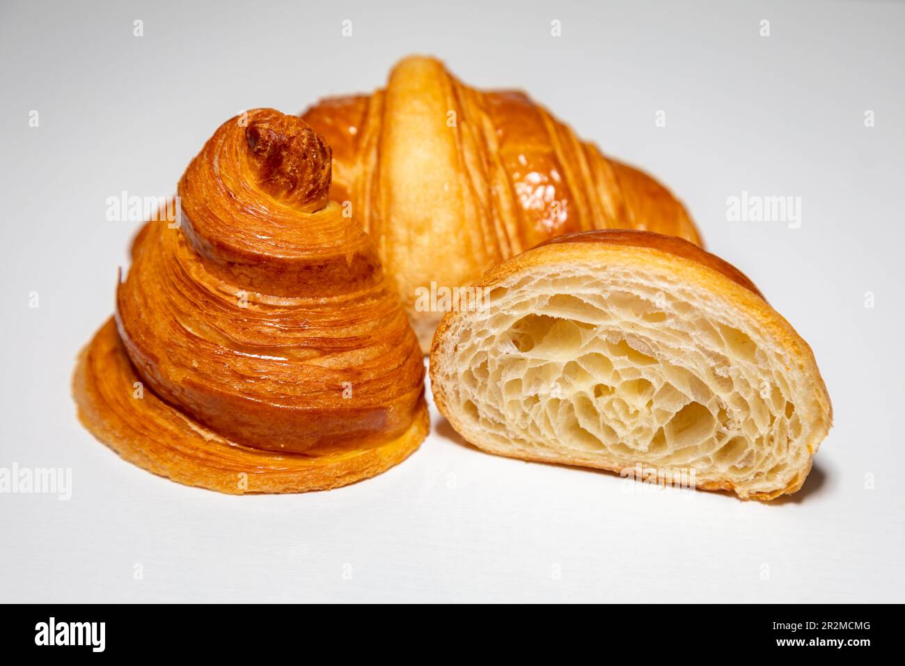 Golden brown butter croissant with shadow isolated on the plain ...