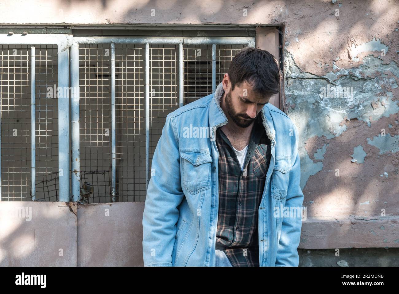 Young sad sick poor homeless man sitting on the street need help ...