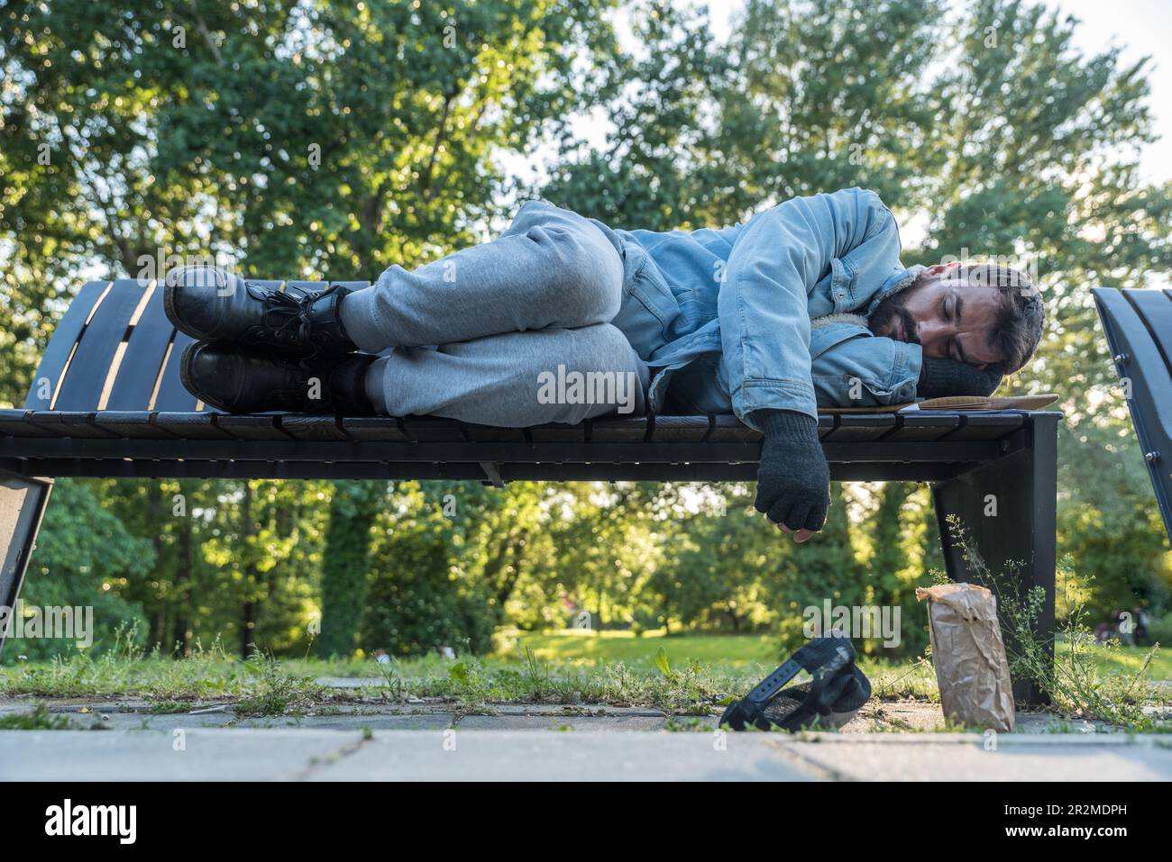 Young sad sick poor homeless man sitting on the street need help ...