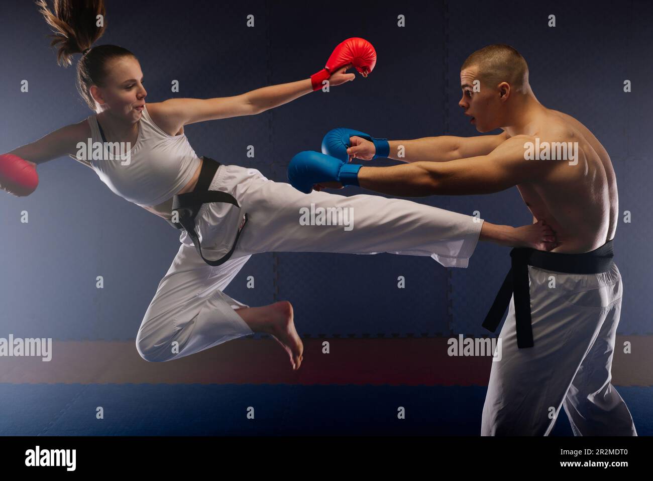 Two young karatists working out the Yoko Tobi Geri pose at the karate ...