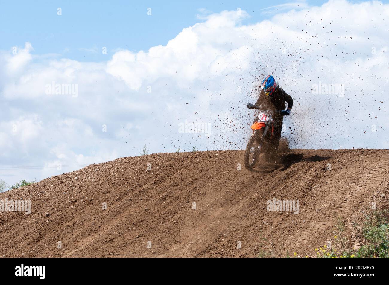 Unrecognized athlete riding a sports motorbike jumping on the air on a ...