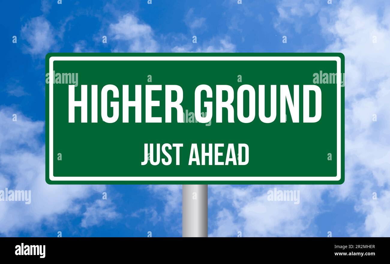 Higher Ground just ahead road sign on sky background Stock Photo - Alamy