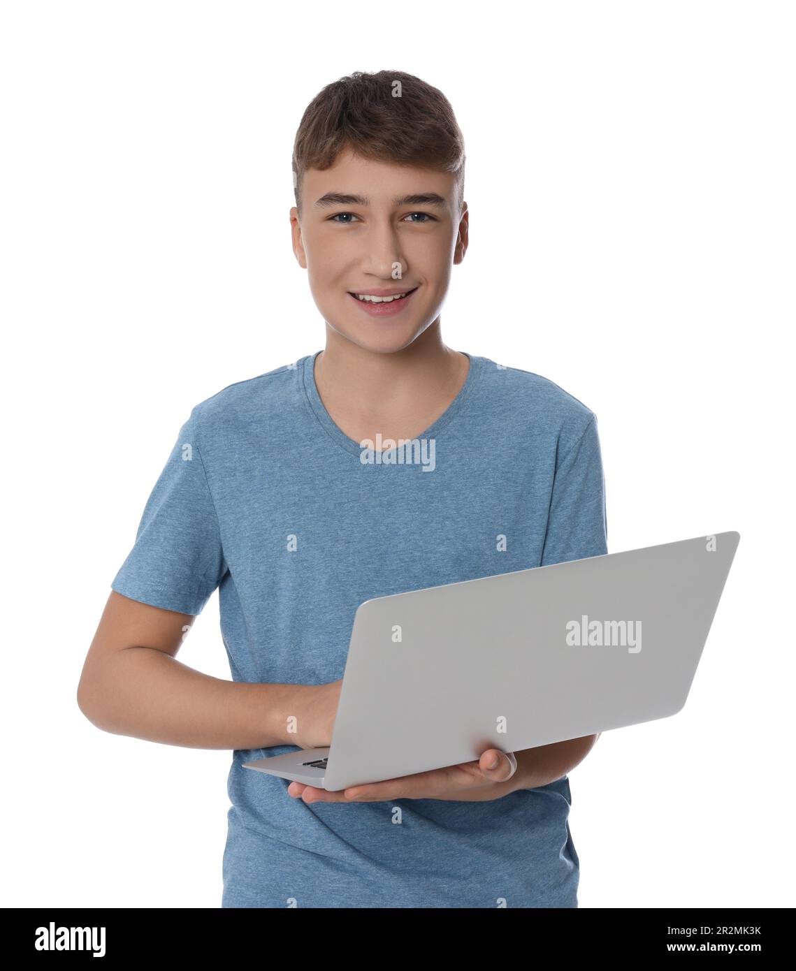 Teenage boy using laptop on white background Stock Photo - Alamy