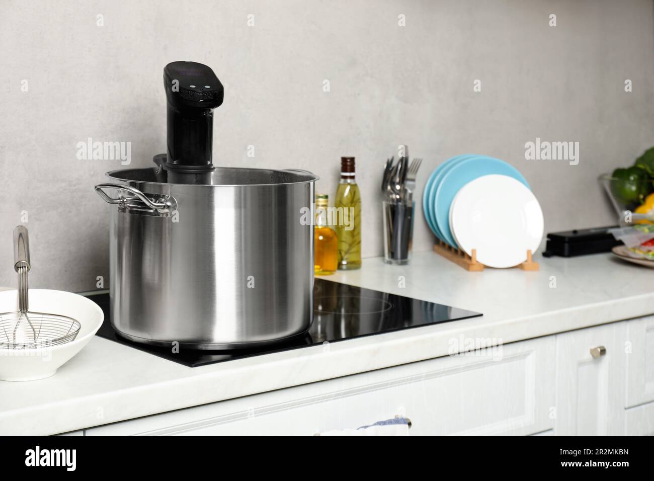 Pot with sous vide cooker in kitchen. Thermal immersion circulator ...