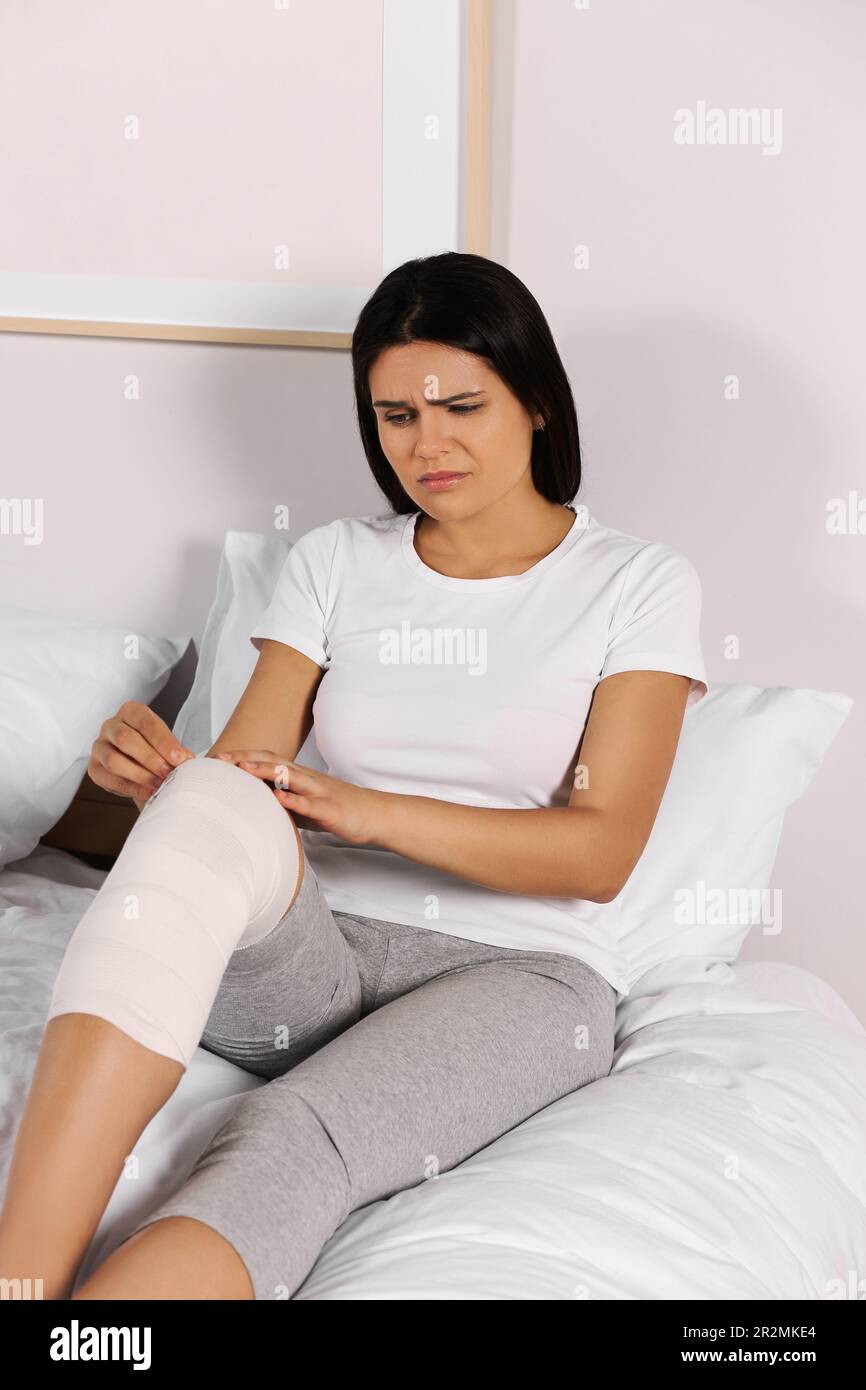 Young woman with leg wrapped in medical bandage in bedroom Stock Photo ...