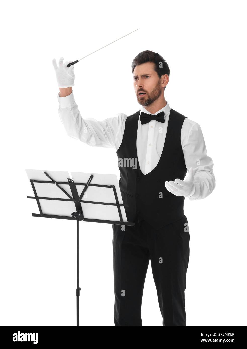 Professional conductor with baton and note stand on white background ...