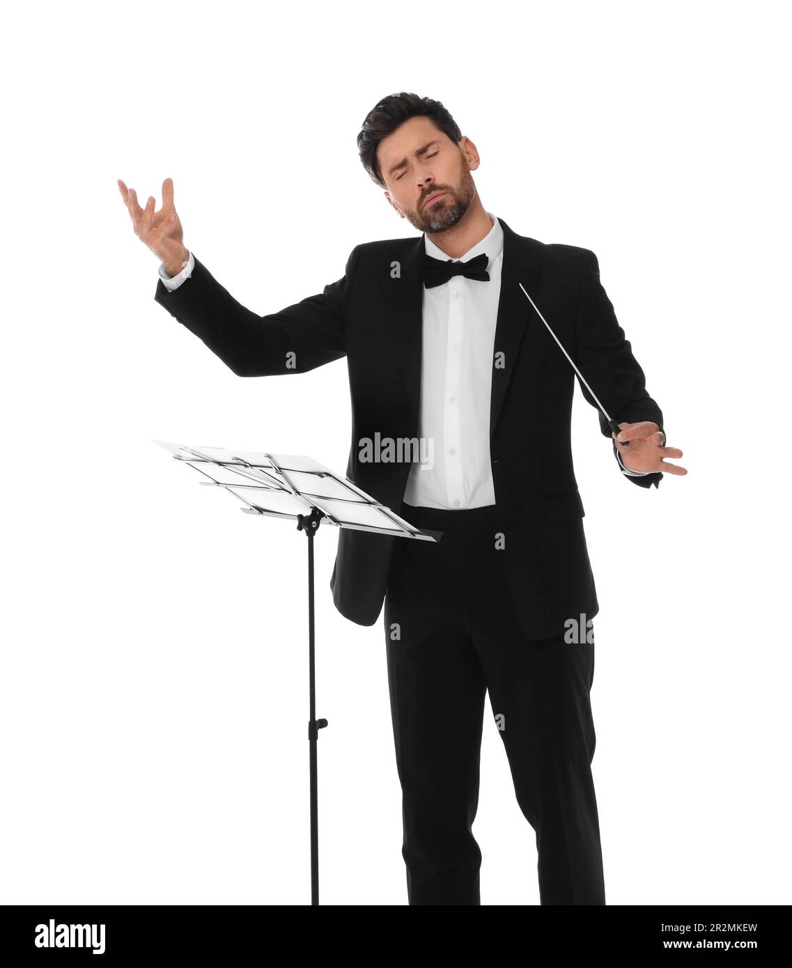 Professional conductor with baton and note stand on white background ...