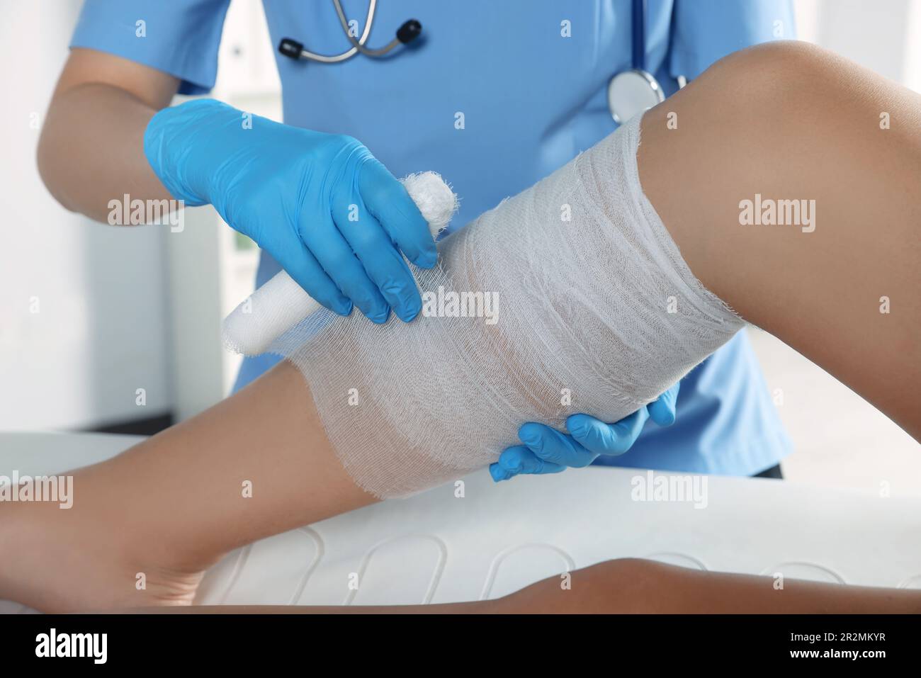 Doctor applying bandage onto patient's shin in hospital, closeup Stock ...