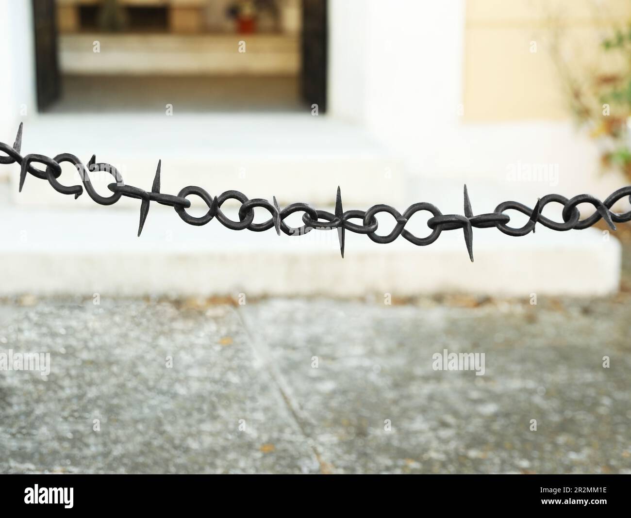 Beautiful black chain with spikes near building outdoors Stock Photo ...