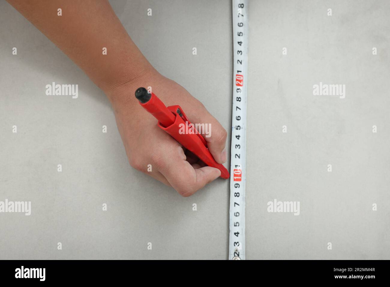 Worker measuring and marking ceramic tile, closeup Stock Photo - Alamy