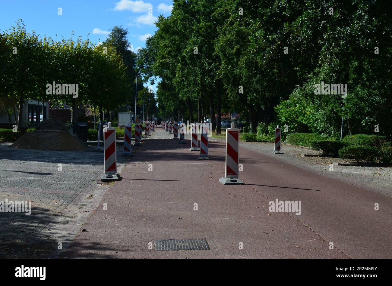 Striped road warning posts on city street Stock Photo - Alamy