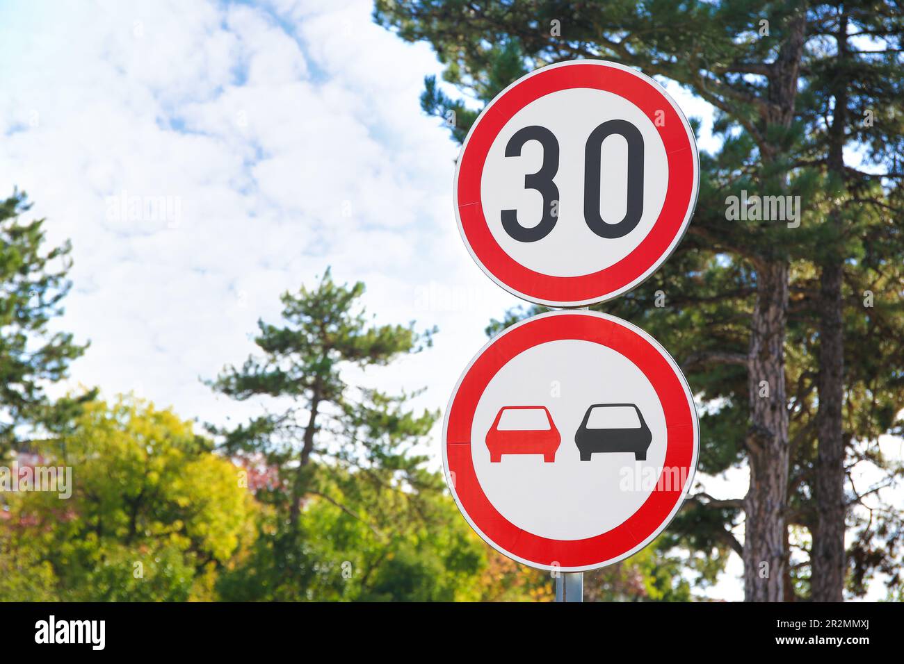 Post with road signs Maximum Speed 30 and No Overtaking outdoors. Space ...