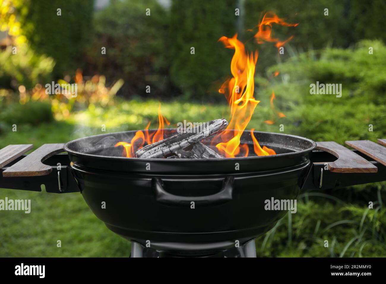 Portable barbecue grill with fire flames outdoors, closeup Stock Photo ...