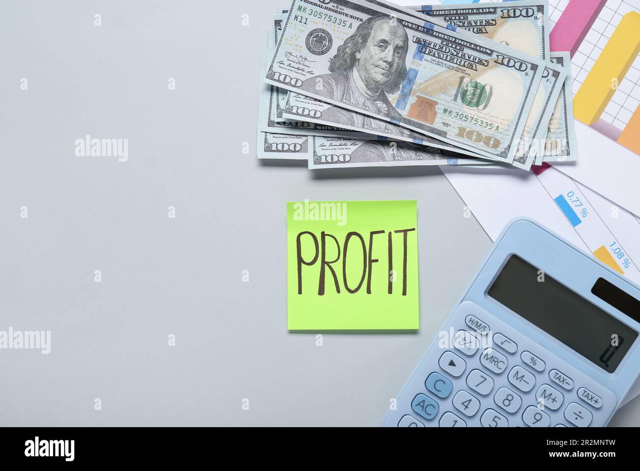 Sticky note with word Profit, calculator, banknotes and diagram on ...