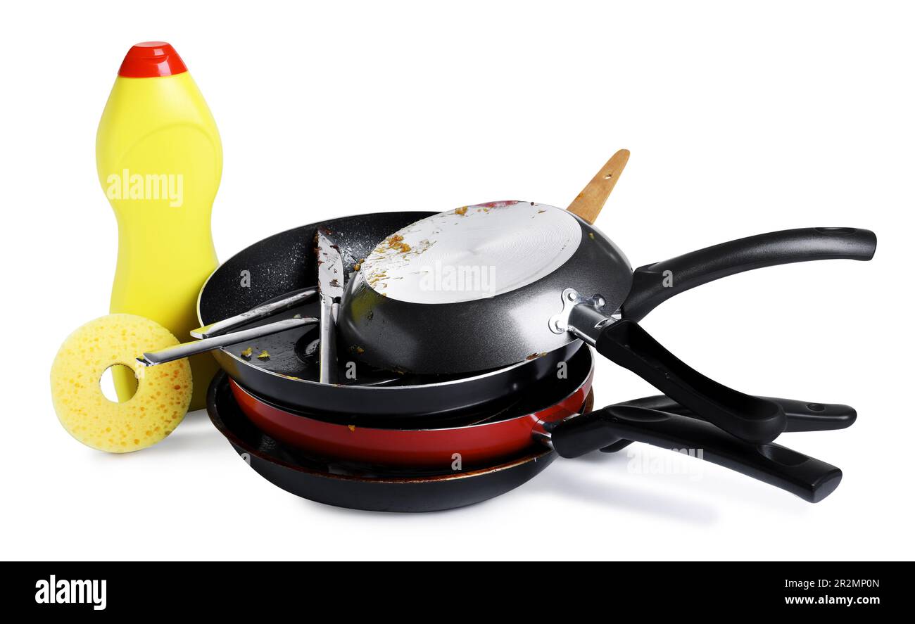 Stack of dirty kitchenware, dish detergent and sponge on white ...