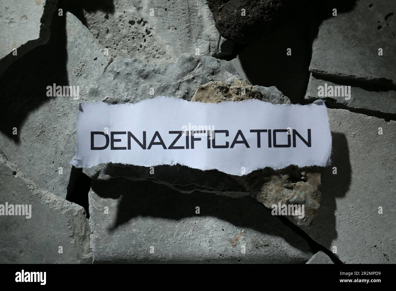 Paper with word Denazification on pieces of concrete, top view Stock ...