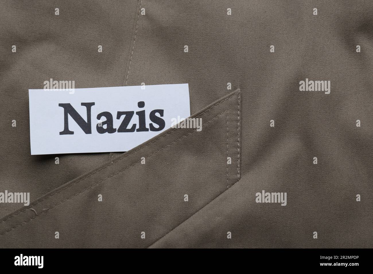 Card with word Nazis on grey jacket, top view Stock Photo - Alamy