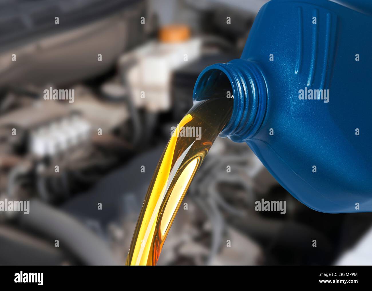 Pouring motor oil from blue container, closeup Stock Photo - Alamy