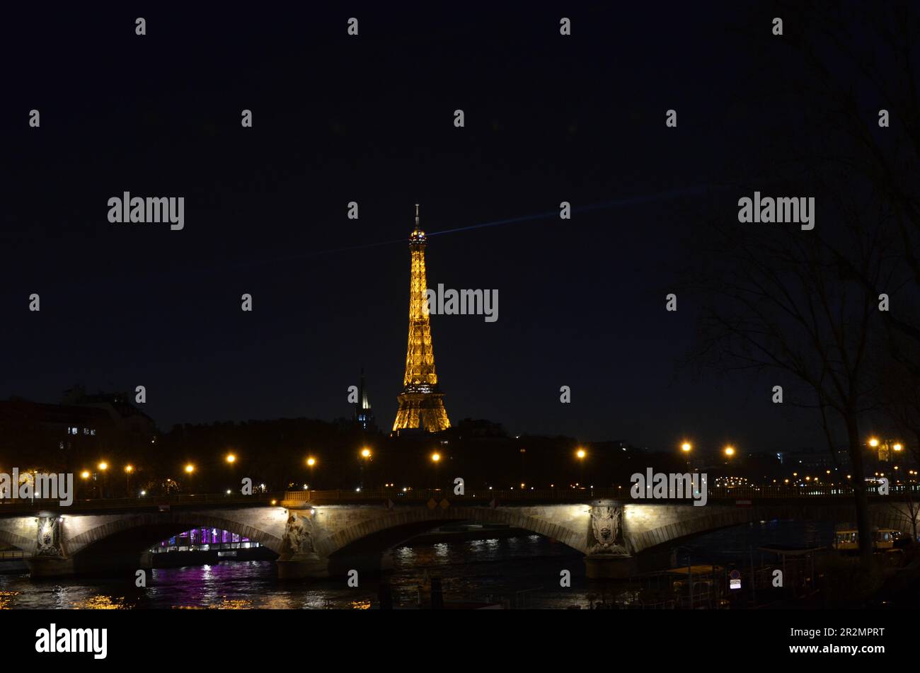 Paris, France - December 10, 2022: Picturesque view of city, Pont d'Iéna bridge and illuminated ...