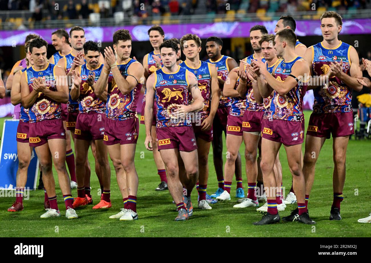 Lachie Neale (centre) of the Lions is seen with team mates after ...