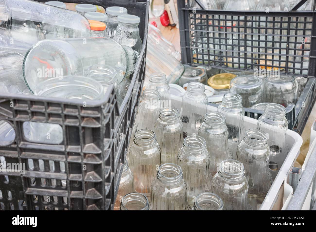 Used empty glass bottles stored in containers for recycling, selective ...