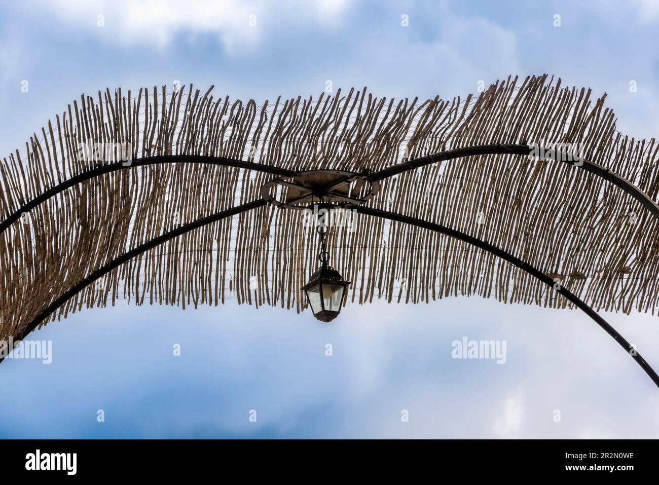 Rustic canopy with metal support shielding light. San Gimignano, Siena ...