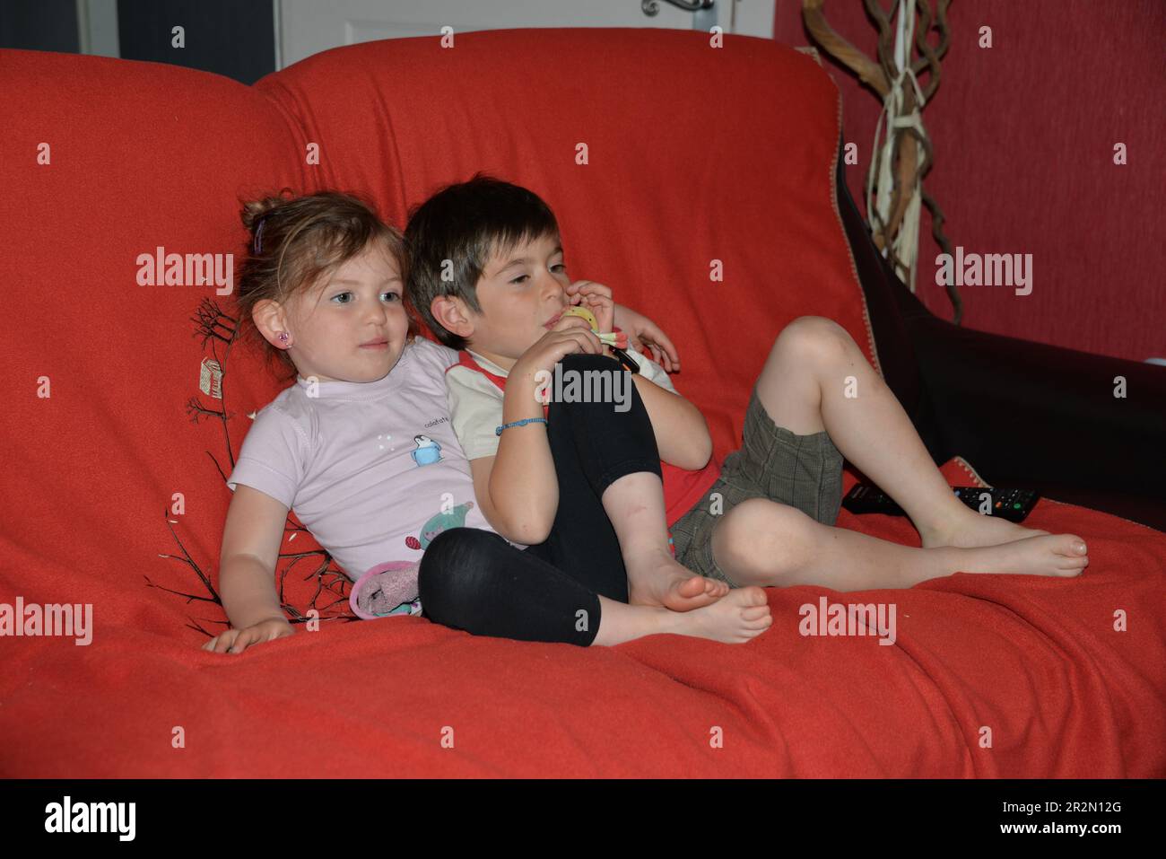 Brother and sister watching a TV program Stock Photo - Alamy
