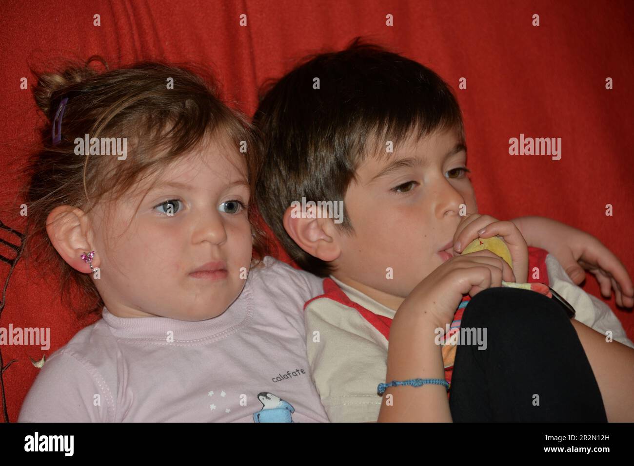 Brother and sister watching a TV program Stock Photo - Alamy