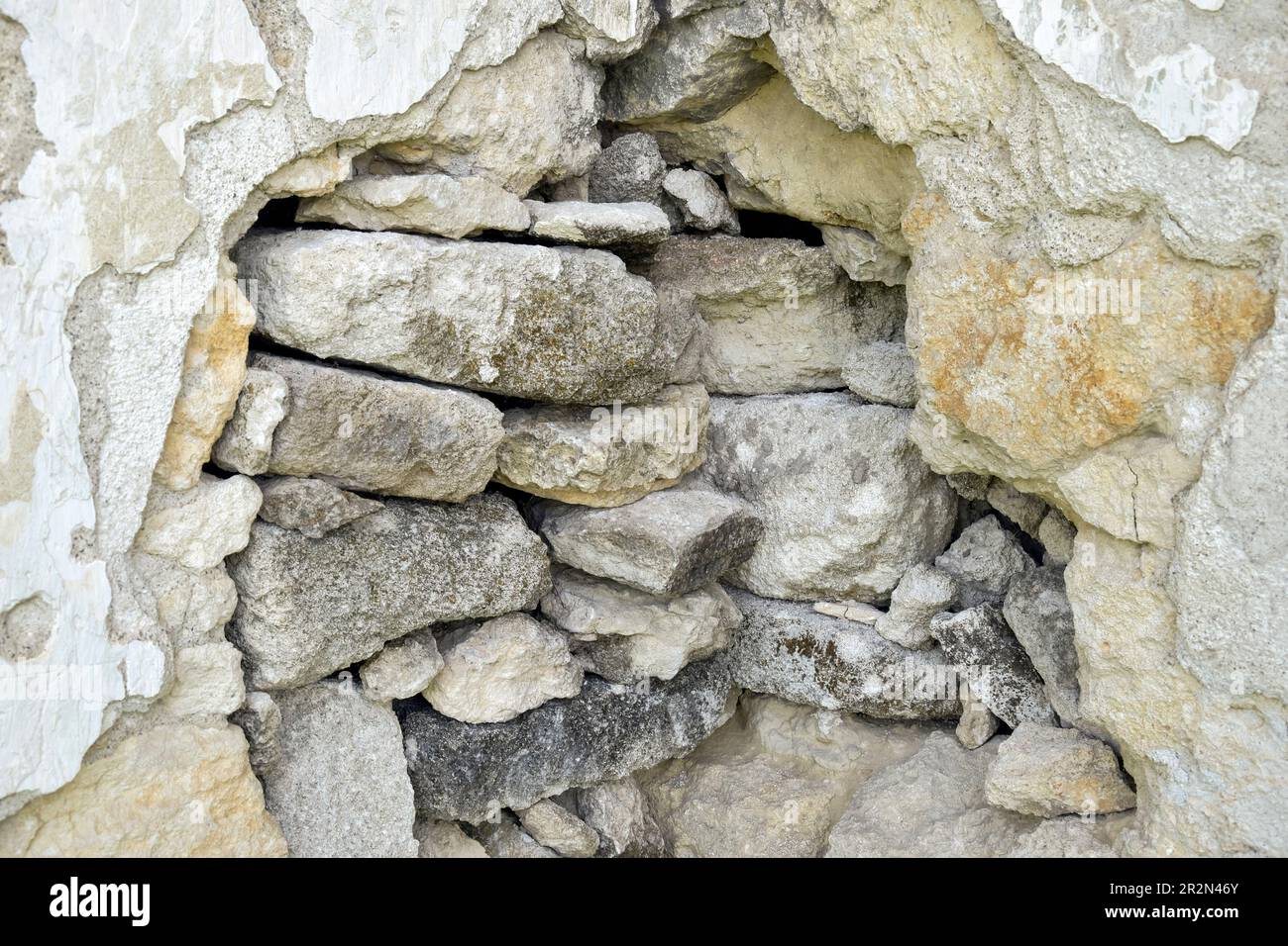 Part of the destroyed old wall. The hole in the wall is filled with ...