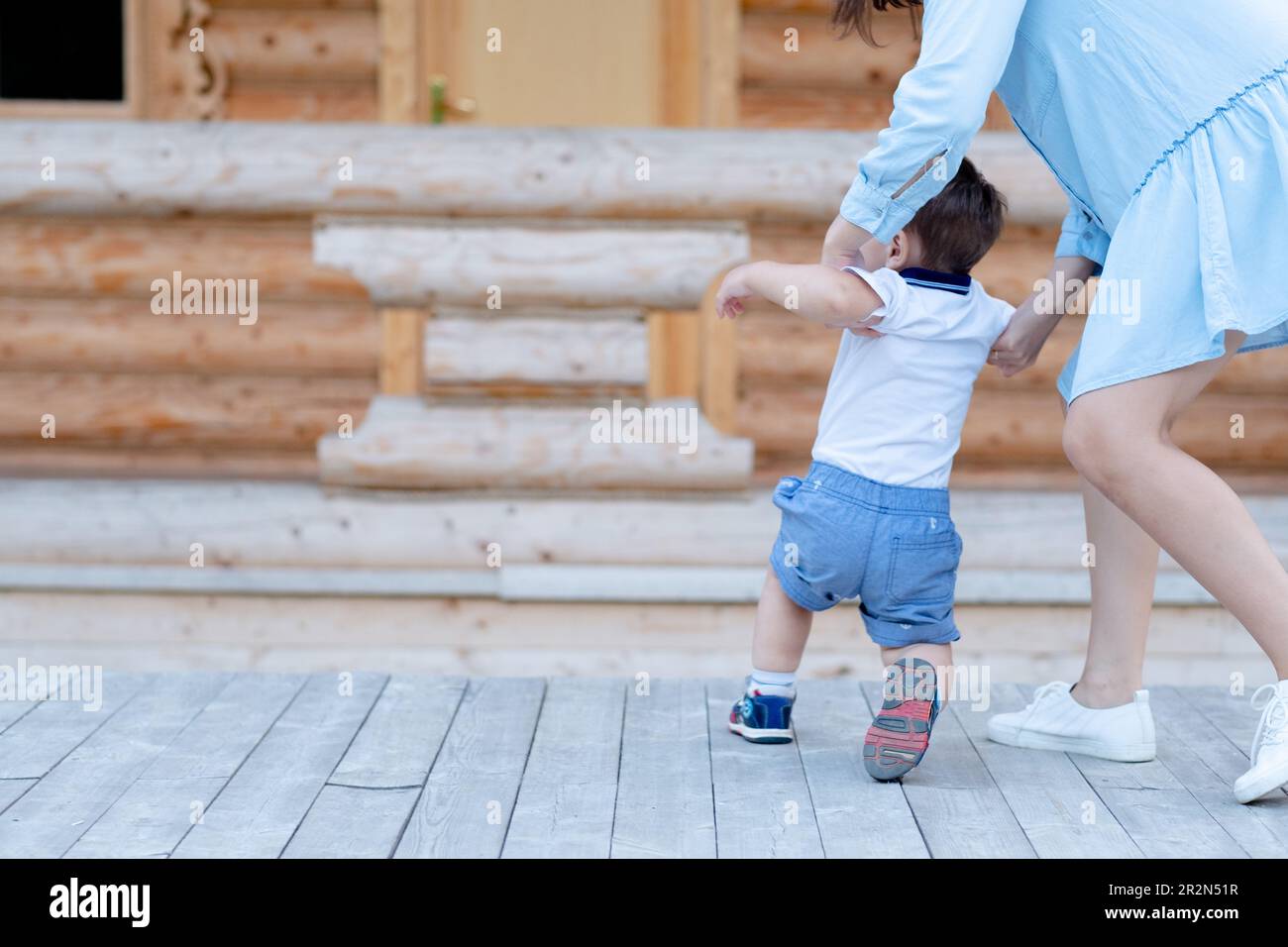 the boy learns to walk and takes his first steps with his mother. Baby ...