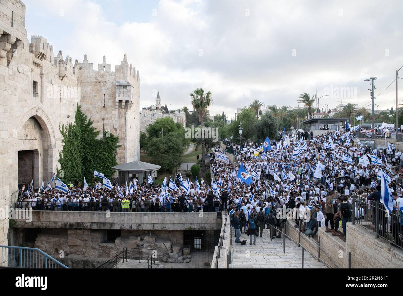 Israeli religious youth wave Israeli flags as they walk pass the closed ...